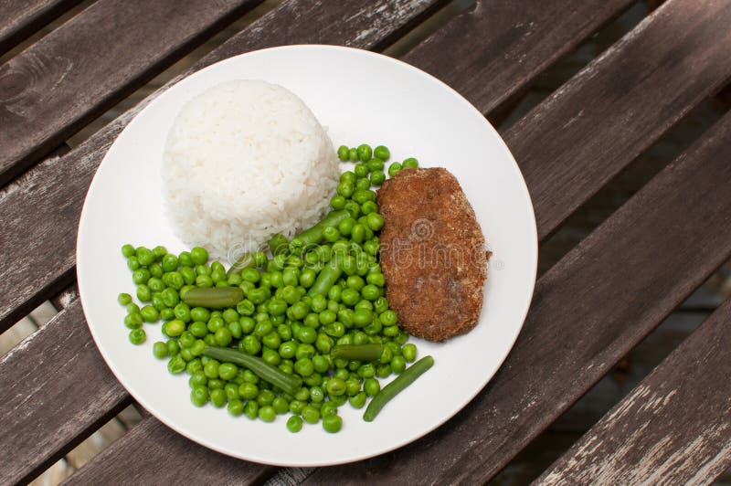 Cutlet Dinner with Rice and Green Peas Stock Photo - Image of bleu ...