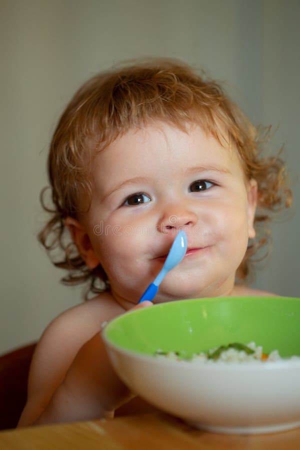 Cutr Baby Child Eating Himself with a Spoon. Stock Photo - Image of ...