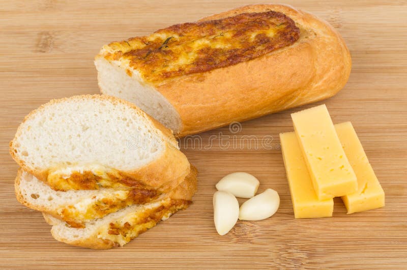 Cutted Baguette, Garlic and Pieces of Cheese on Table Stock Photo ...