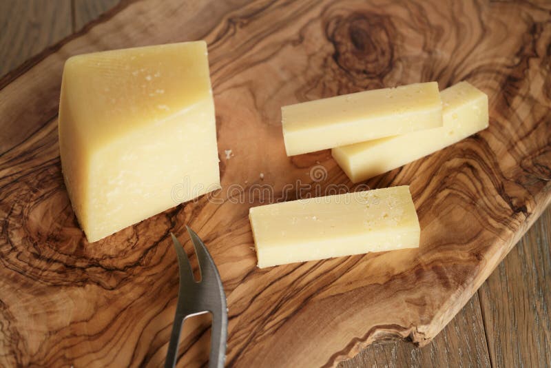Cutted Parmesan Cheese on Olive Cutting Board Stock Image - Image of ...