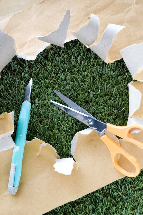 Cutter and Scissors on Torn Paper Stock Photo - Image of scissors ...