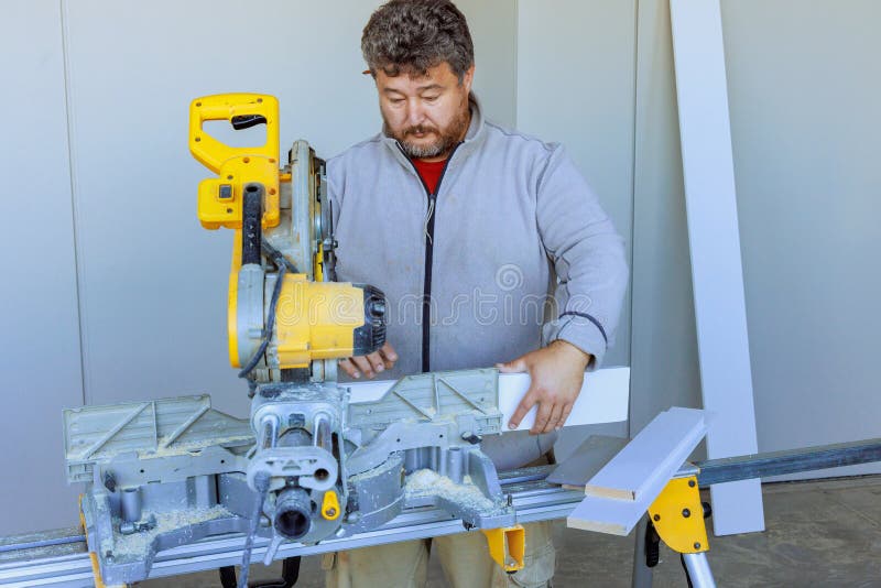 Cutting Base Moldings with a Chop Saw is Task Performed by Trim Worker ...