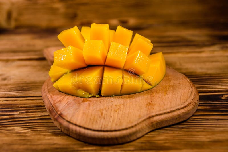 Cutting Board with Chopped Mango Fruit on a Wooden Table Stock Image ...