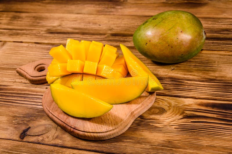 Cutting Board with Chopped Mango Fruit on a Wooden Table Stock Image ...