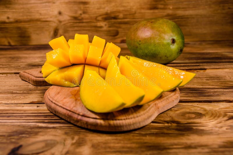 Cutting Board with Chopped Mango Fruit on a Wooden Table Stock Image ...
