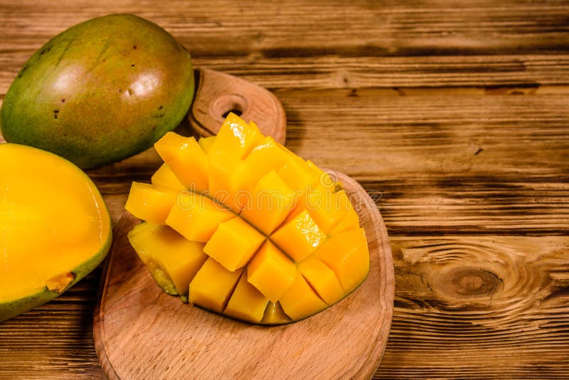 Cutting Board with Chopped Mango Fruit on a Wooden Table Stock Image ...