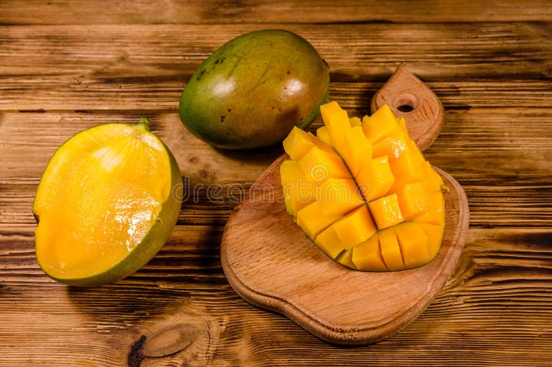 Cutting Board with Chopped Mango Fruit on a Wooden Table Stock Photo ...