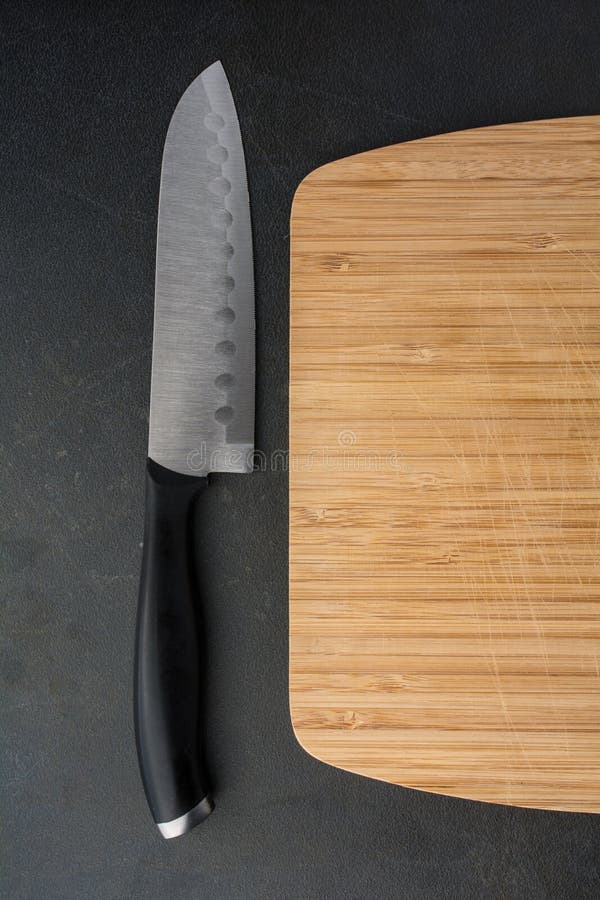 Cutting Board with Knife on Black Counter Stock Photo - Image of ...