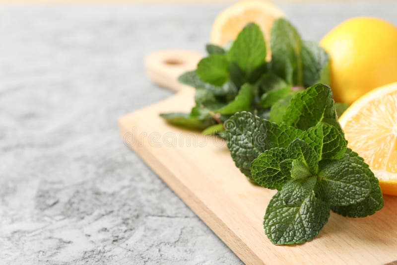 Cutting Board with Lemon and Mint on Background, Close Up Stock Photo ...