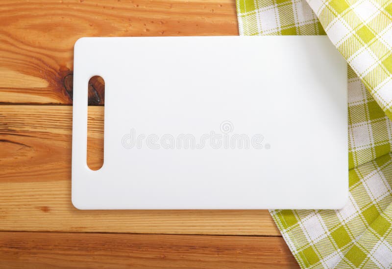 Cutting Board Over Towel on Wooden Kitchen Table. Top View Stock Photo ...