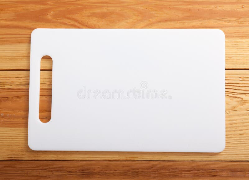 Cutting Board Over Towel on Wooden Kitchen Table. Top View Stock Image ...