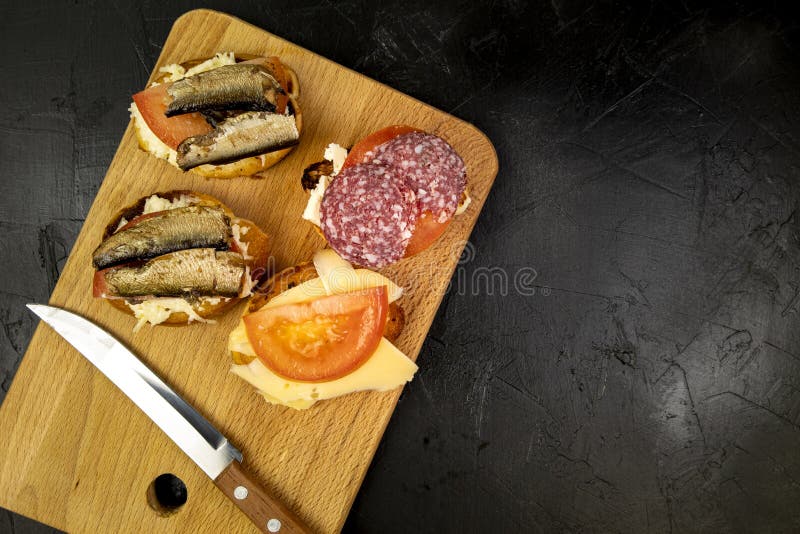 Cutting Board with Sandwiches, Snacks on Black, Top View, Space for ...