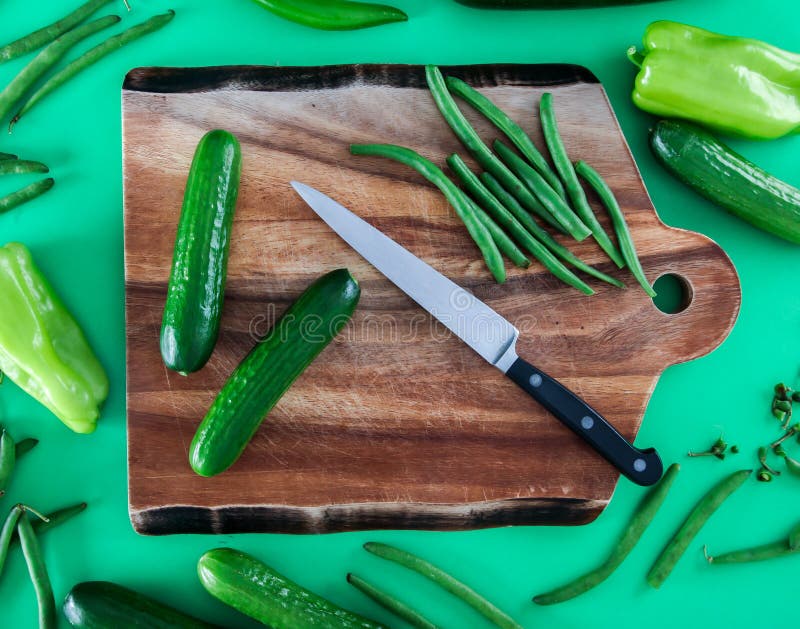 Cutting Board with Vegetables on Green Background Stock Photo - Image ...