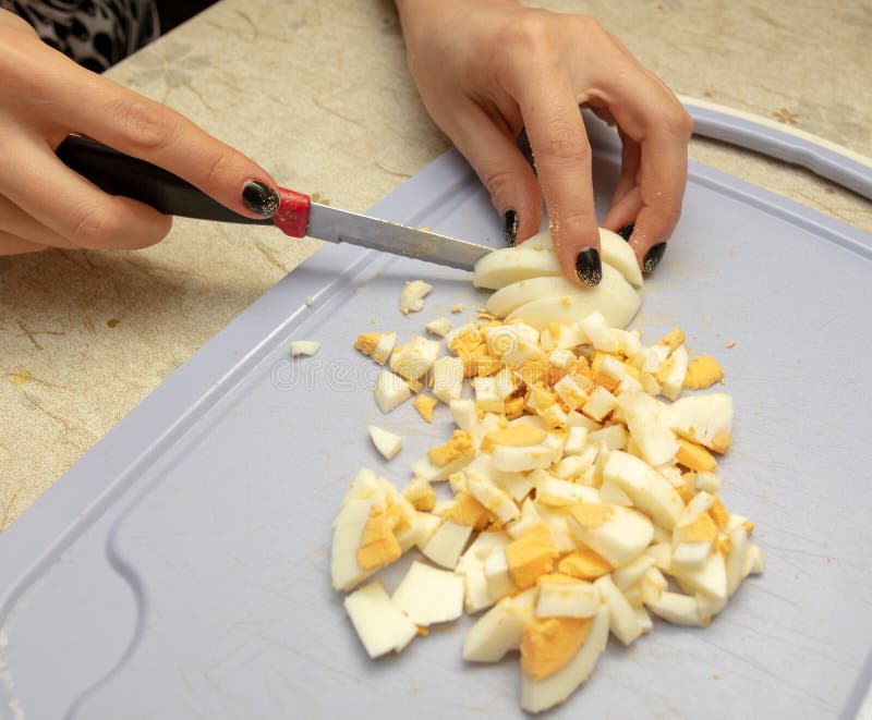 Boiled Eggs And A Knife On The Cutting Board In The Kitchen Stock Photo ...