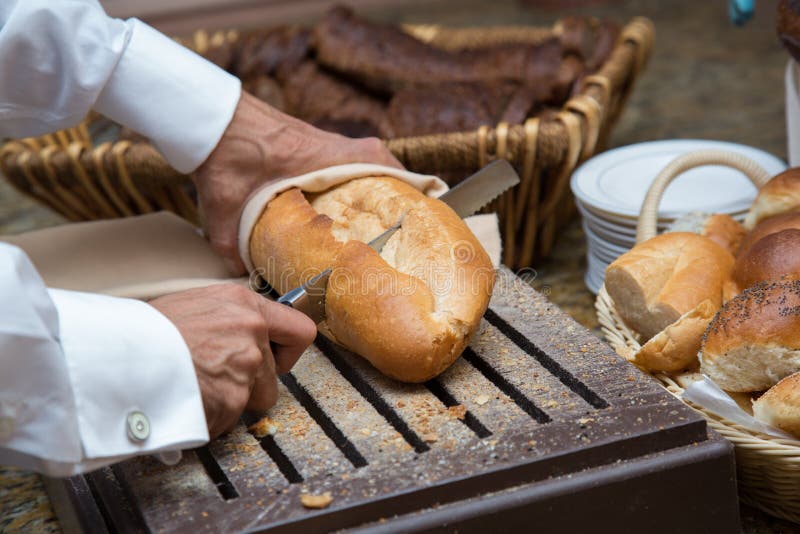 Cutting bread loaf stock image. Image of holding, hand - 26760417