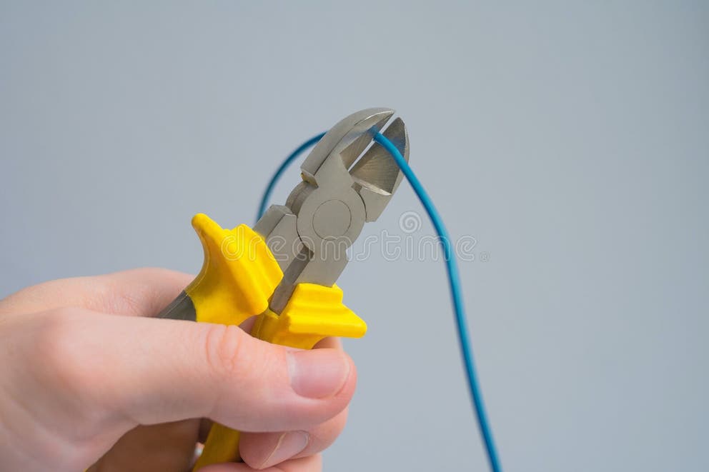 Cutting a cable with plier stock photo. Image of cable - 273649572