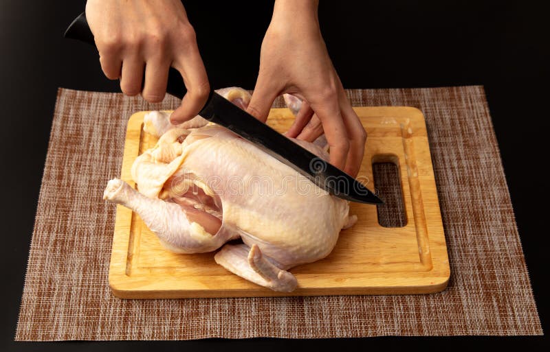 Cutting Chicken Carcass on a Board on a Black Background Stock Image ...