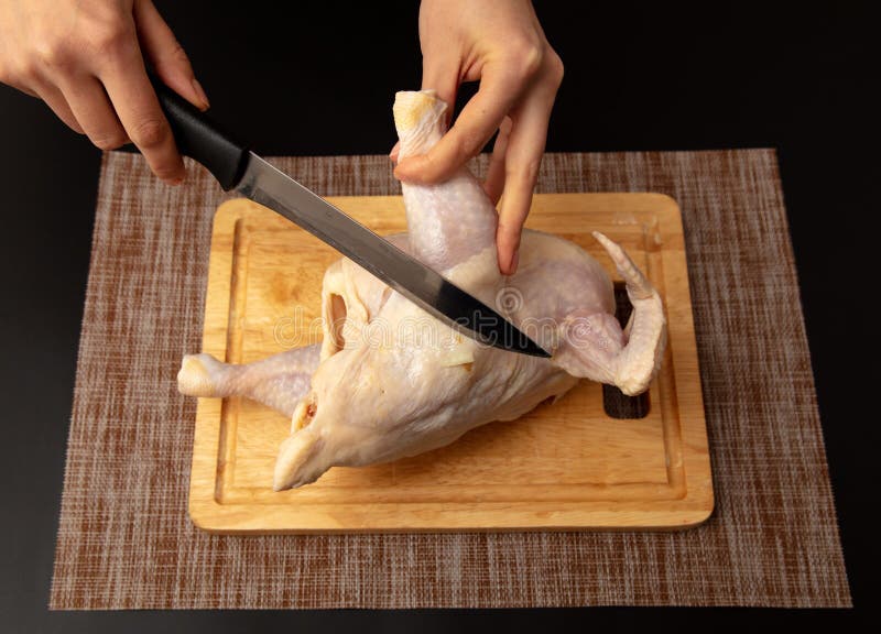 Cutting Chicken Carcass on a Board on a Black Background Stock Photo ...