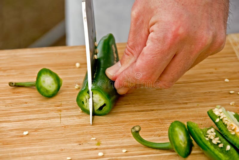 Cutting chili pepper stock photo. Image of hold, spicy - 13268880