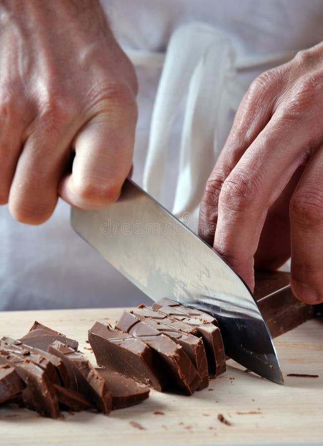 Cutting a Chocolate Cake Decorated with Roses Stock Photo - Image of ...