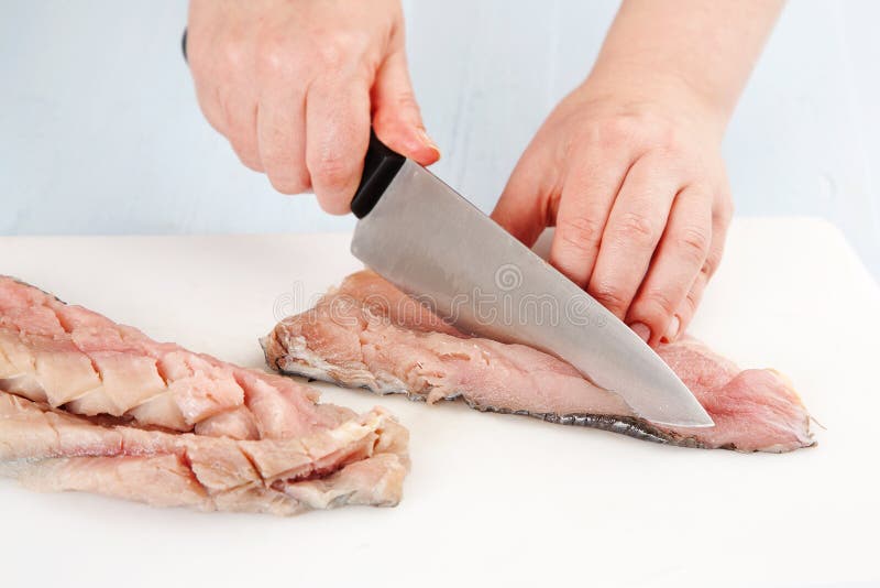 Cutting cod fillets stock image. Image of closeup, food - 49107435