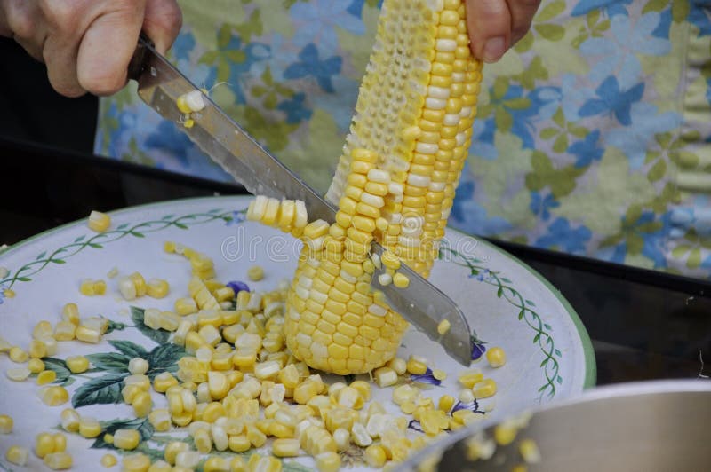 Cutting corn of the cob stock photo. Image of kernel - 125606924