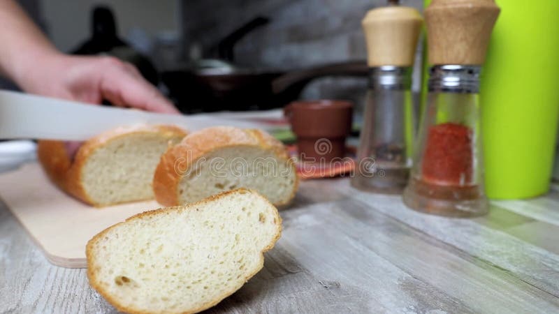 Cutting Fresh Bread into Pieces in Kitchen Interior with a Special ...