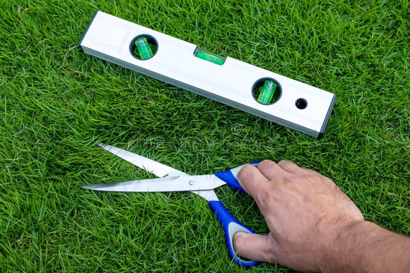 Cutting the Grass with Scissors and Using the Level Tool To Level the ...