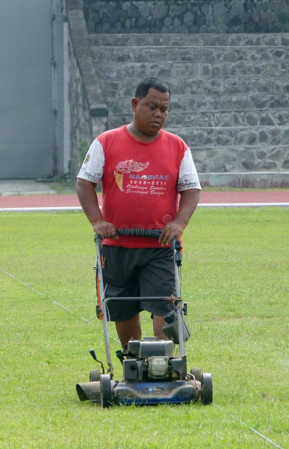 Cutting grass editorial image. Image of cutting, central - 65595160