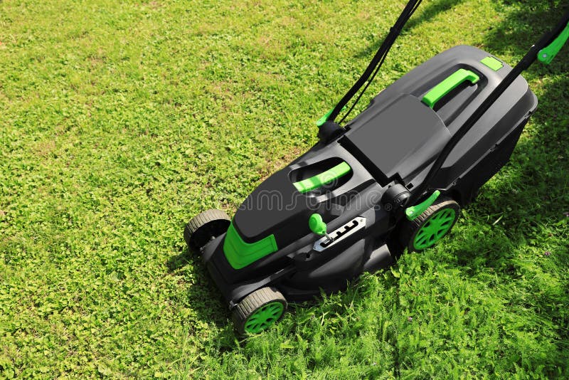 Cutting Green Grass with Lawn Mower in Garden Stock Image - Image of ...