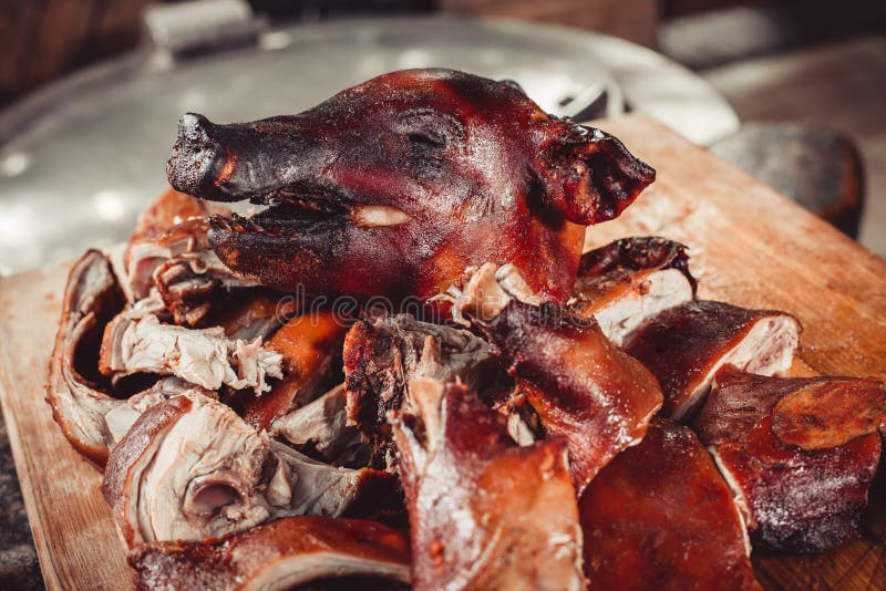Cutting Grilled Pig on Wooden Table. Hot Meat Stock Photo - Image of ...