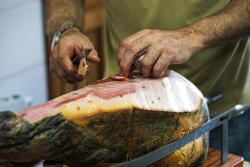 Cutting ham with a knife stock photo. Image of carving - 380357276