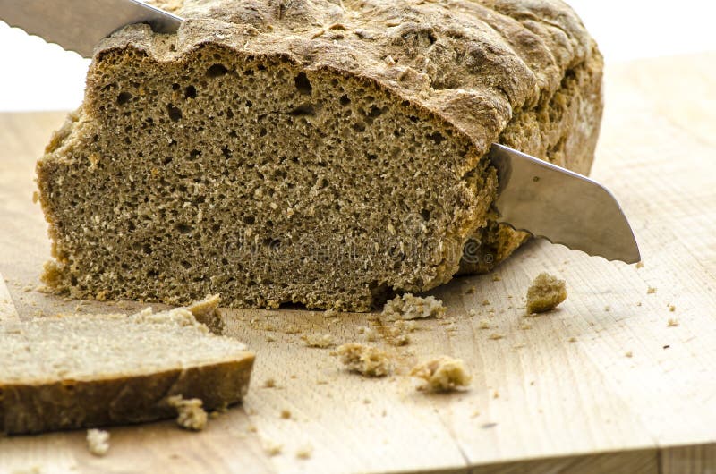 Cutting a homemade bread stock image. Image of single - 27767547