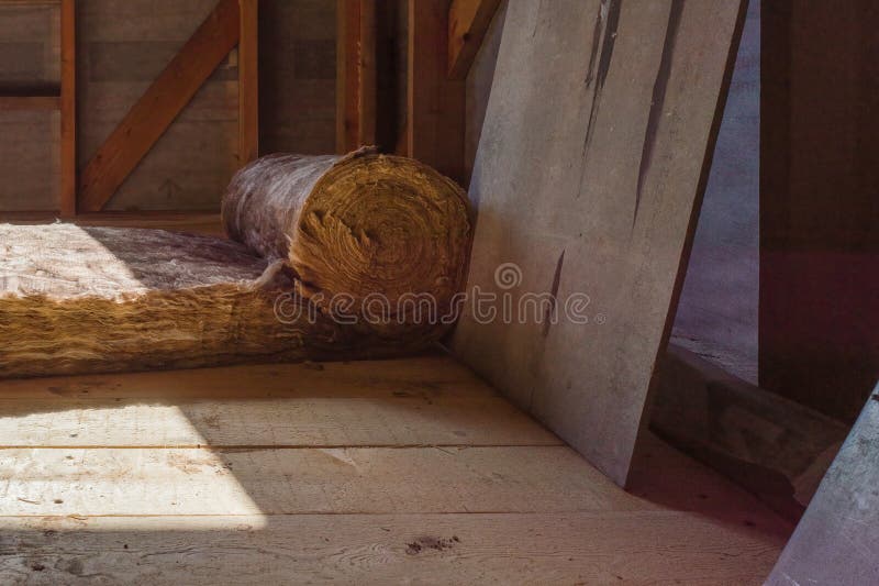 Cutting Insulation for Laying in a Frame House Under Construction ...