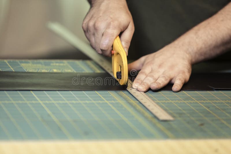 Using a Rotary Leather Cutter on a Grided Cutting Board Stock Photo ...