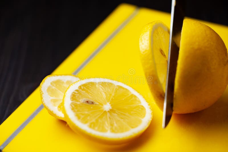 Cutting lemon in pieces stock image. Image of fresh - 230384631
