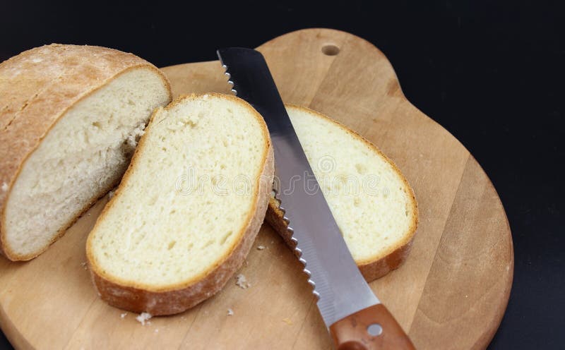Cutting Loaf of Bread with Knife on Cutting Board Stock Photo - Image ...