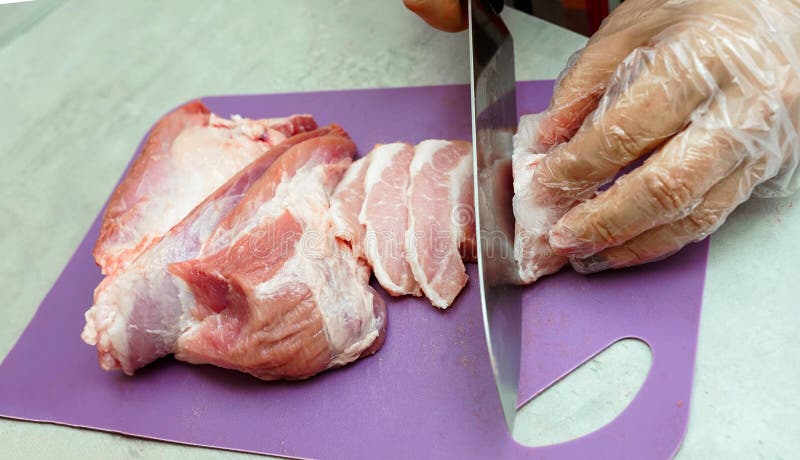 Cutting meat with a knife stock image. Image of butcher - 158201435