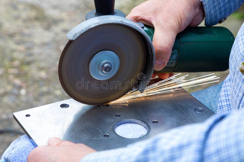 Cutting Metal with a Grinder. Processing and Grinding of Metal with ...