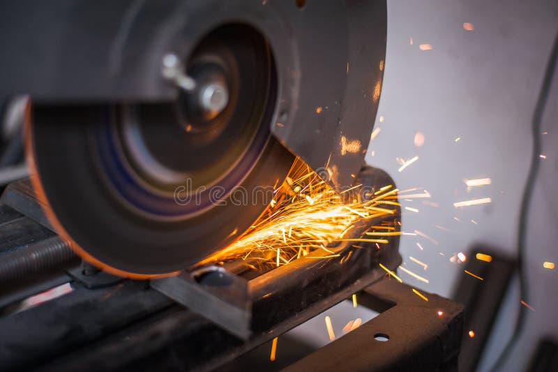 Cutting Metal with Grinder in Workshop. Sparks while Grinding Iron ...