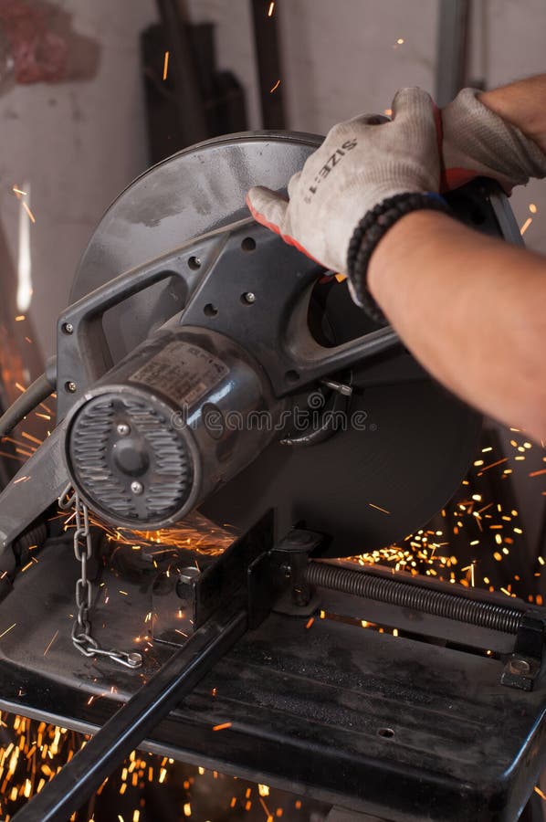 Cutting Metal with Grinder in Workshop. Sparks while Grinding Iron ...
