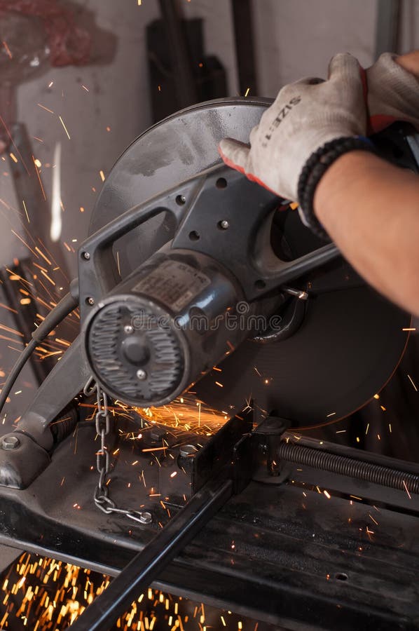 Cutting Metal with Grinder in Workshop. Sparks while Grinding Iron ...