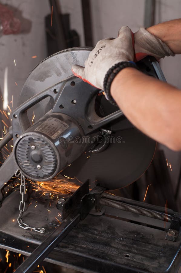 Cutting Metal with Grinder in Workshop. Sparks while Grinding Iron ...