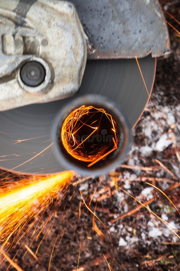 Cutting Metal Pipe with Angle Grinder and Flying Sparks in Workshop ...