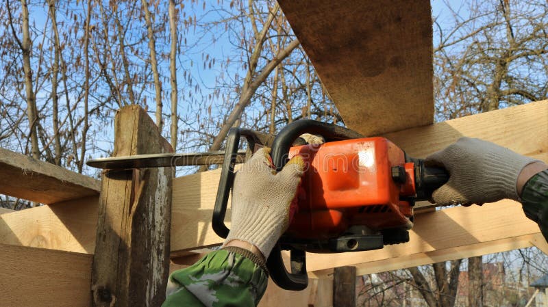 Working with a Chainsaw in the Process of Building a Wooden Frame Stock ...