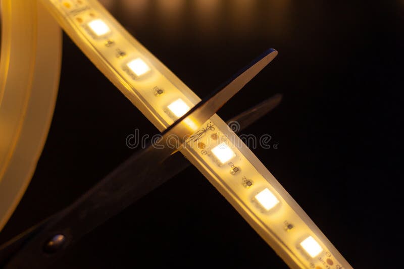 Cut LED Strip with Scissors for Mounting on a Dark Background Stock ...
