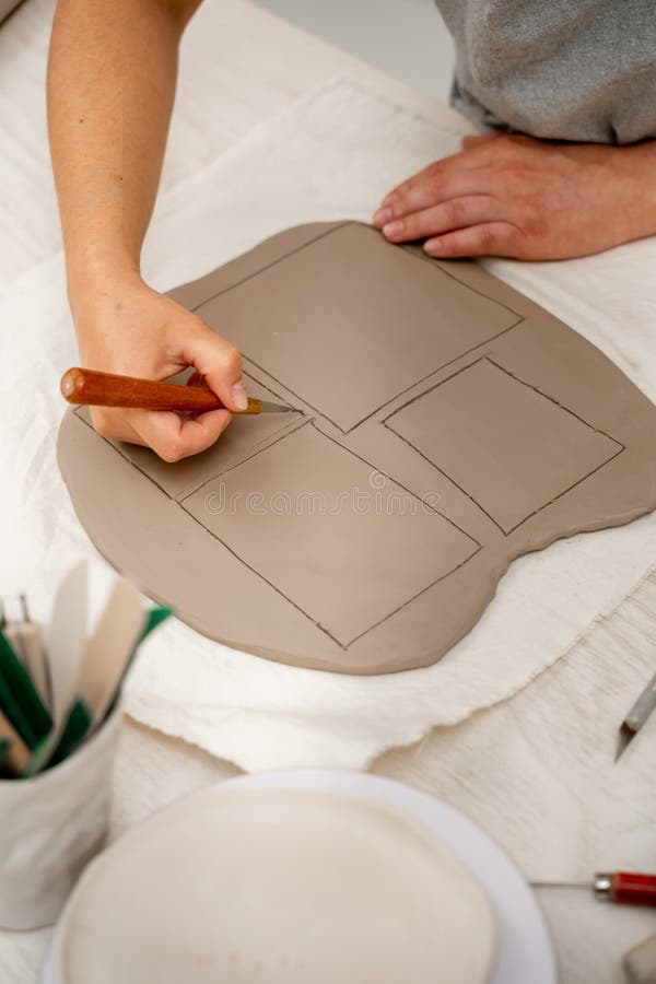 Cutting Out Figures from a Flat Sheet of Clay with a Sculpting Tool ...