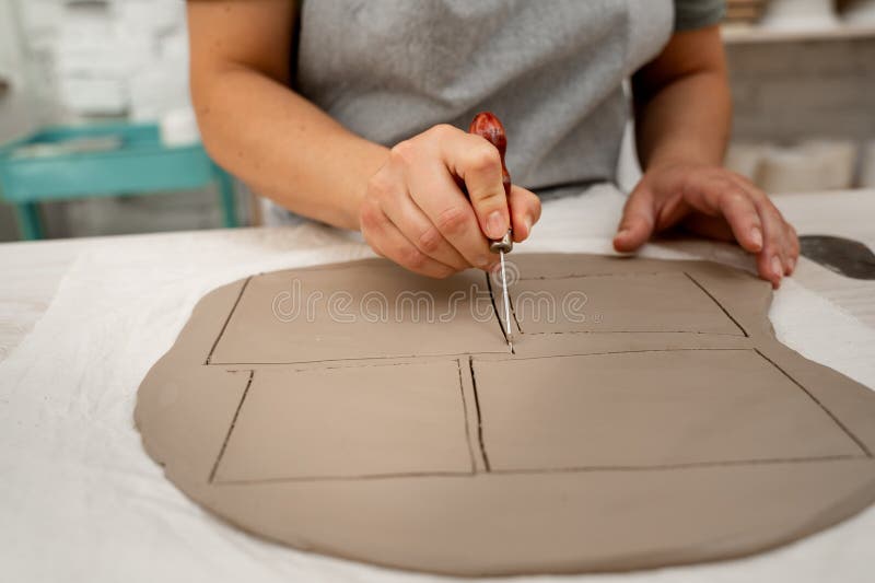 Cutting Out Figures from a Flat Sheet of Clay with a Sculpting Tool ...