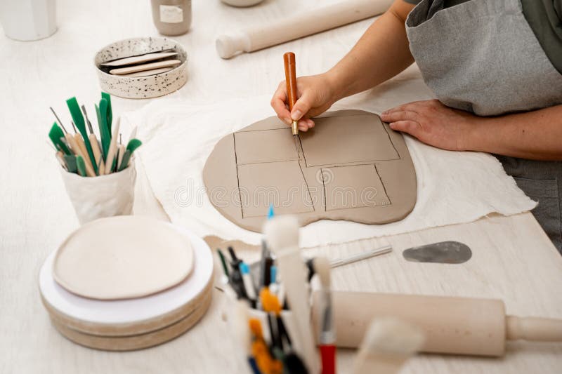 Cutting Out Figures from a Flat Sheet of Clay with a Sculpting Tool ...