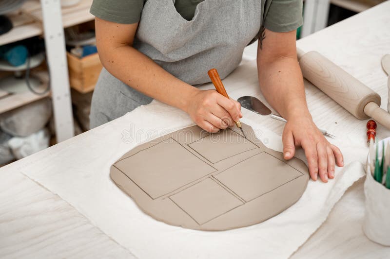Cutting Out Rectangle Figures Out of a Flat Sheet of Clay with a ...